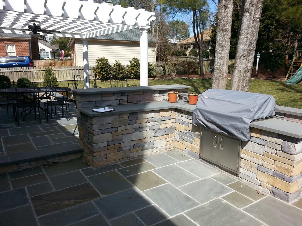 Outdoor kitchen and pergola with a bluestone patio - Patio - Richmond ...