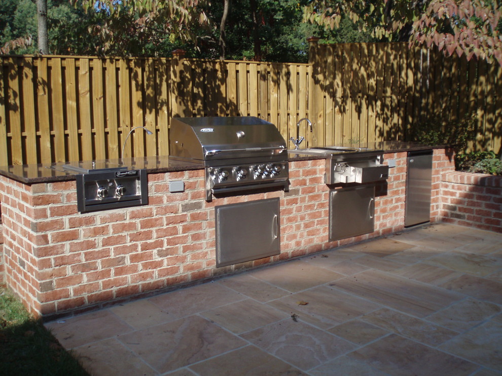 Outdoor Kitchen with Privacy Fence and Stone Patio - Traditional ...