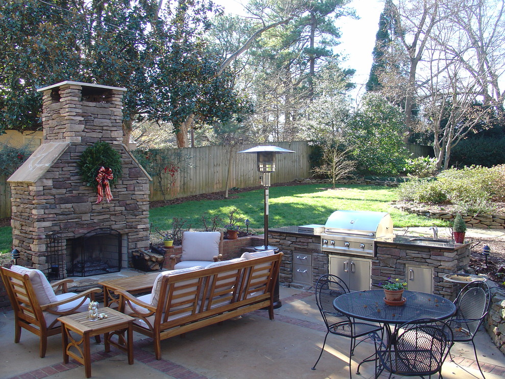 Outdoor kitchen with stacked stone fireplace - Traditional - Patio ...