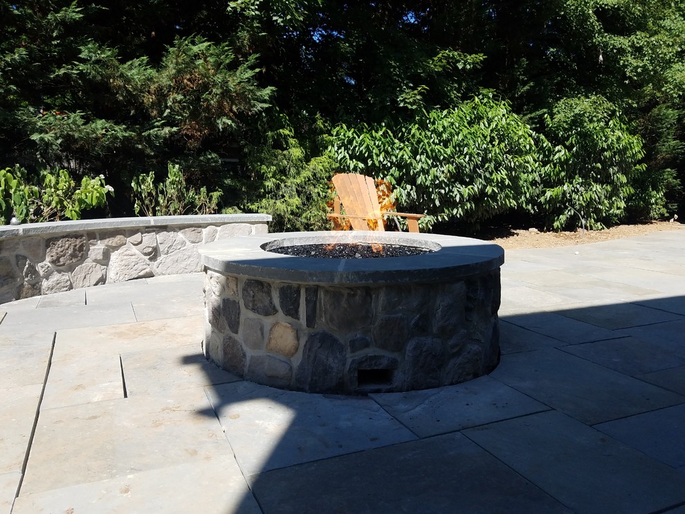 Patio with stone wall and fire pit - Traditional - Patio - New York ...