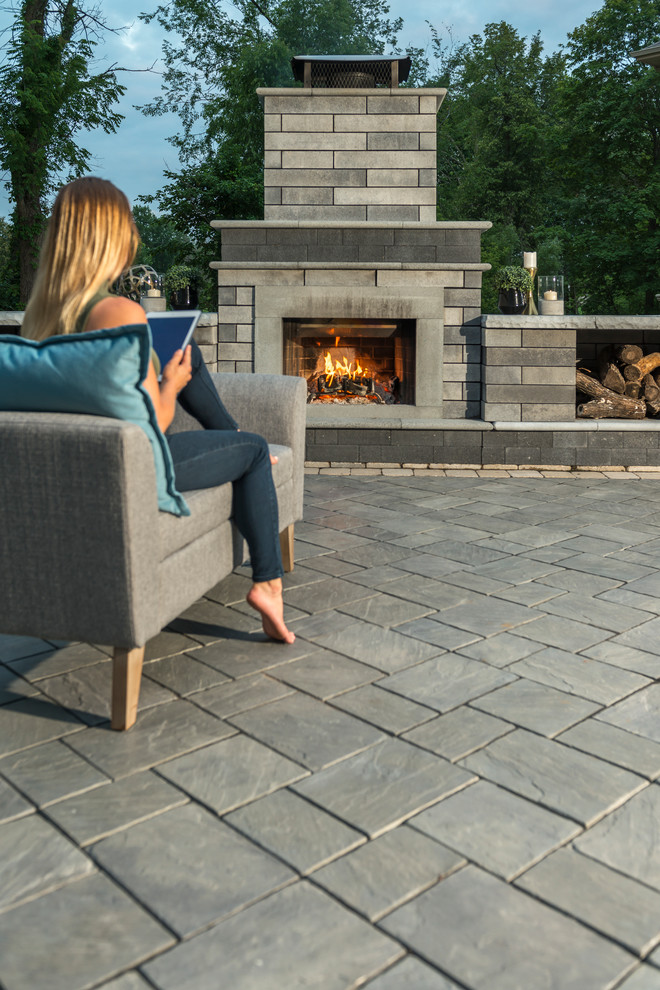 Reading a tablet and enjoying a Richcliff patio and Moda fireplace ...