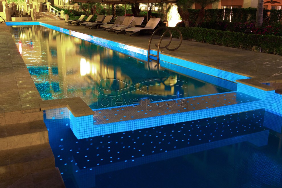1 Resurface of a hotel pool w/glass tile (night time) - Modern - Pool ...