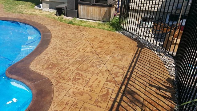Ashlar Slate pool deck with interior, acid stained border and bull-nose ...