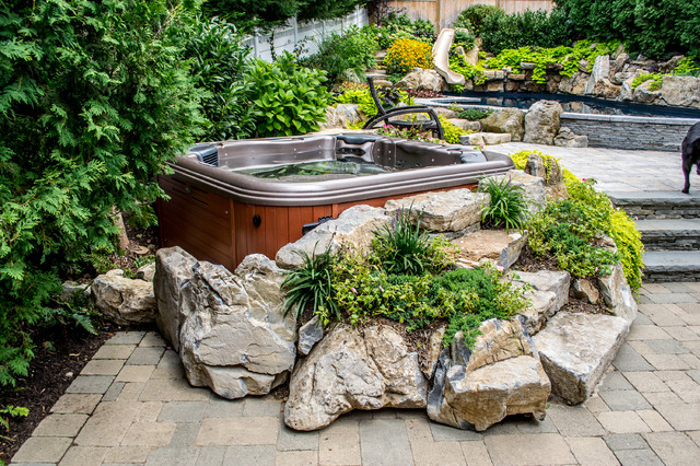 Bullfrog Spas built into boulders and landscaping - Traditional ...