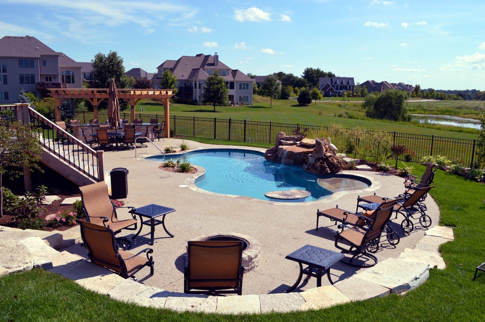 Free form pool with stone table, sun shelf, water feature, and outdoor ...