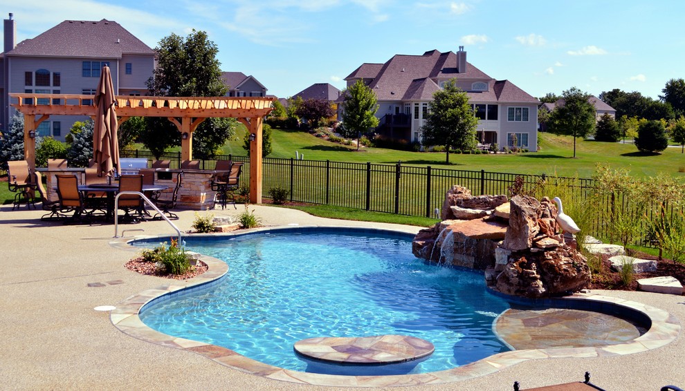 Free form pool with stone table, sun shelf, water feature, and outdoor ...