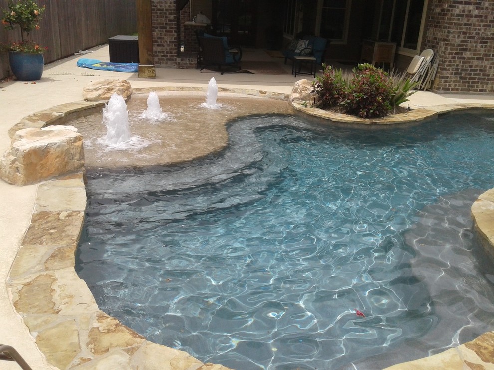 Freeform pool, flagstone coping, beach entry, rico rock boulders ...