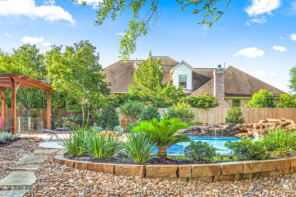Freeform pool, pergola, rock waterfall and beautiful landscaping ...