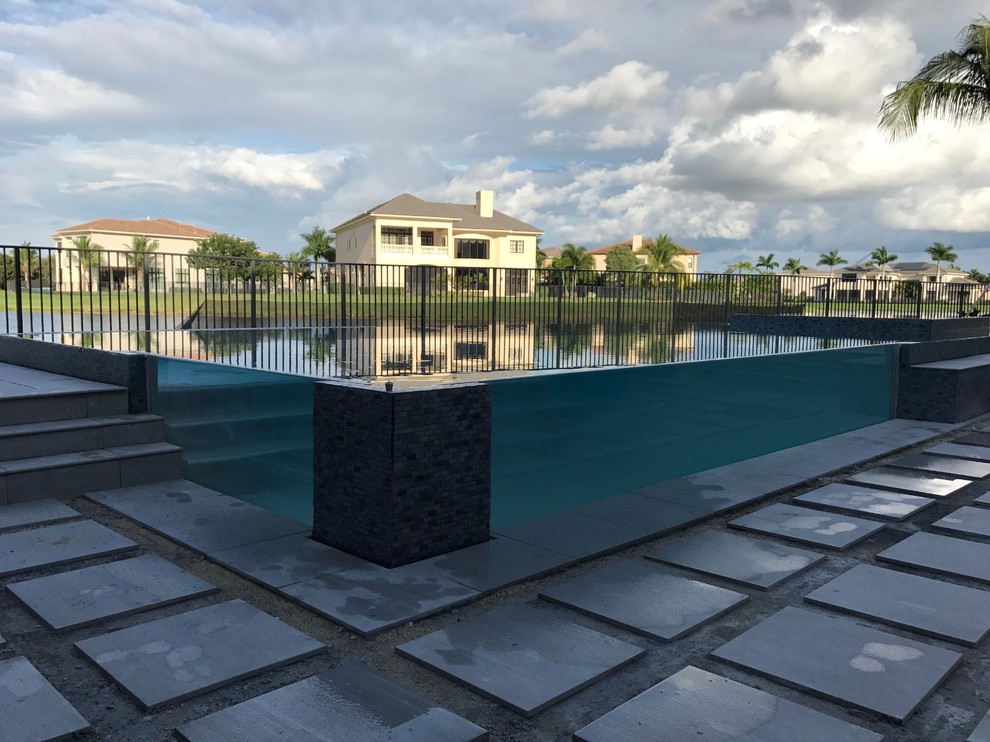 glass wall pool with sunken living room - Industrial - Pool - Miami ...