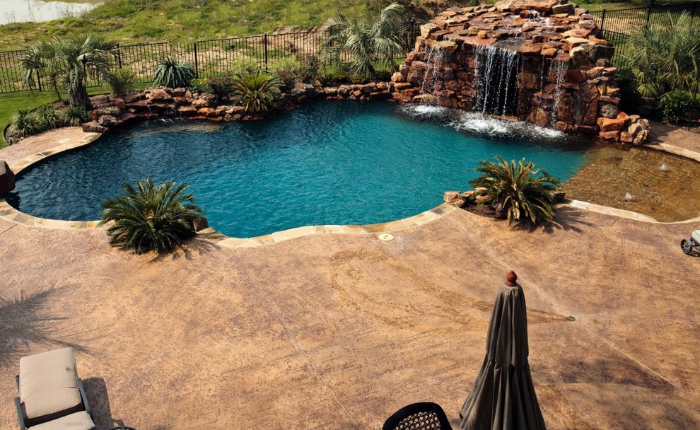 Lagoon style swimming pool with waterfall grotto with spa inside. - Traditional - Pool - Dallas ...