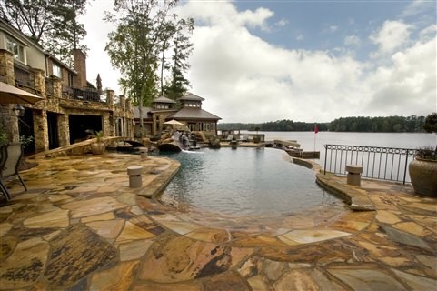 Lake House Pool with a 40' vanishing edge and a carved concrete slide ...