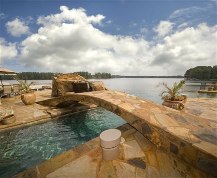 Lake House Pool with a 40' vanishing edge and a carved concrete slide ...
