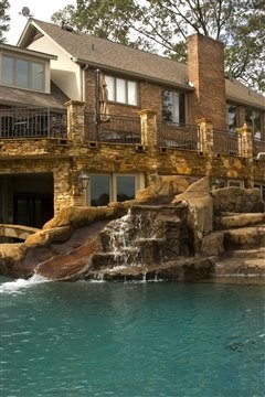 Lake House Pool with a 40' vanishing edge and a carved concrete slide ...