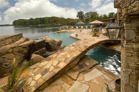 Lake House Pool with a 40' vanishing edge and a carved concrete slide ...