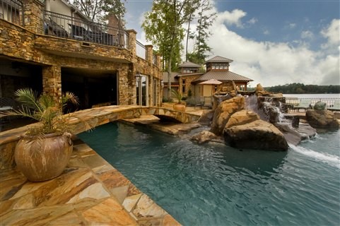 Lake House Pool with a 40' vanishing edge and a carved concrete slide ...