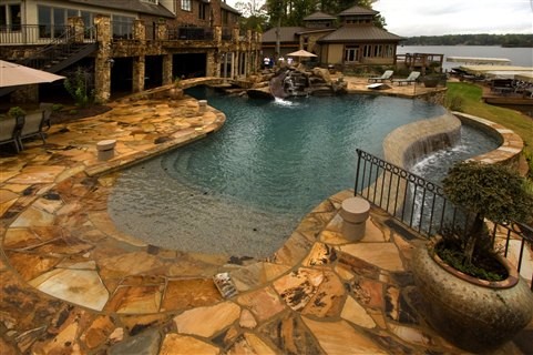 Lake House Pool with a 40' vanishing edge and a carved concrete slide ...