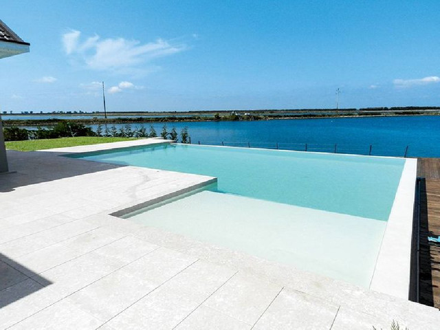 Modern pool with light colored cement look porcelain tile - Modern ...