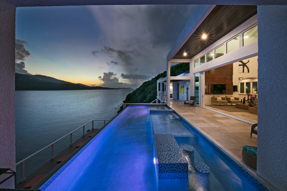 Night time view of an infinity pool with lighting in a contemporary St ...
