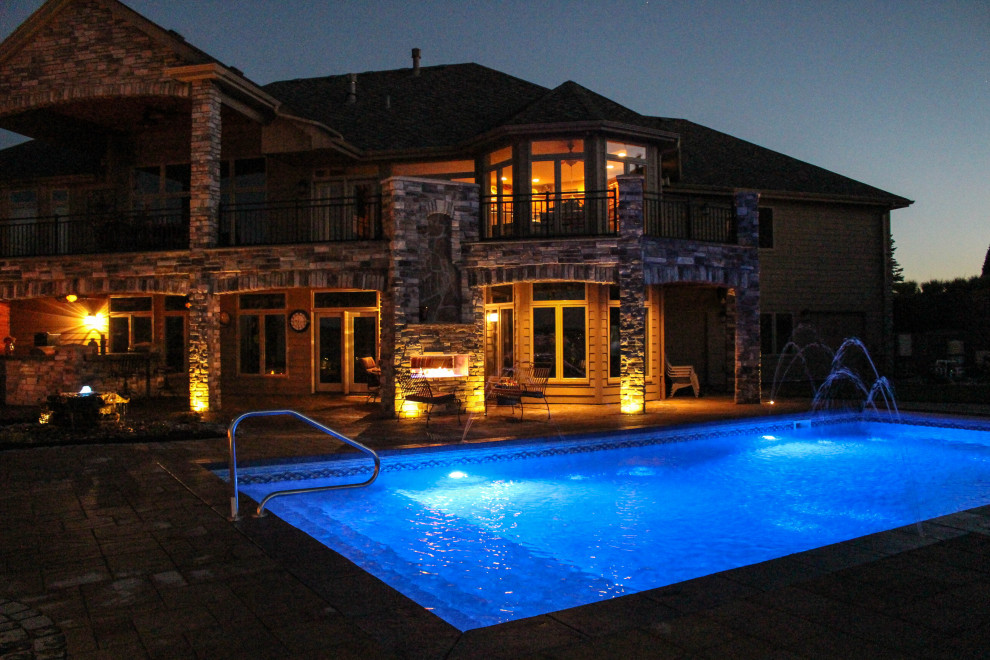 Nighttime Swimming Pool With Water Weirs and Fire Place - Modern - Pool ...