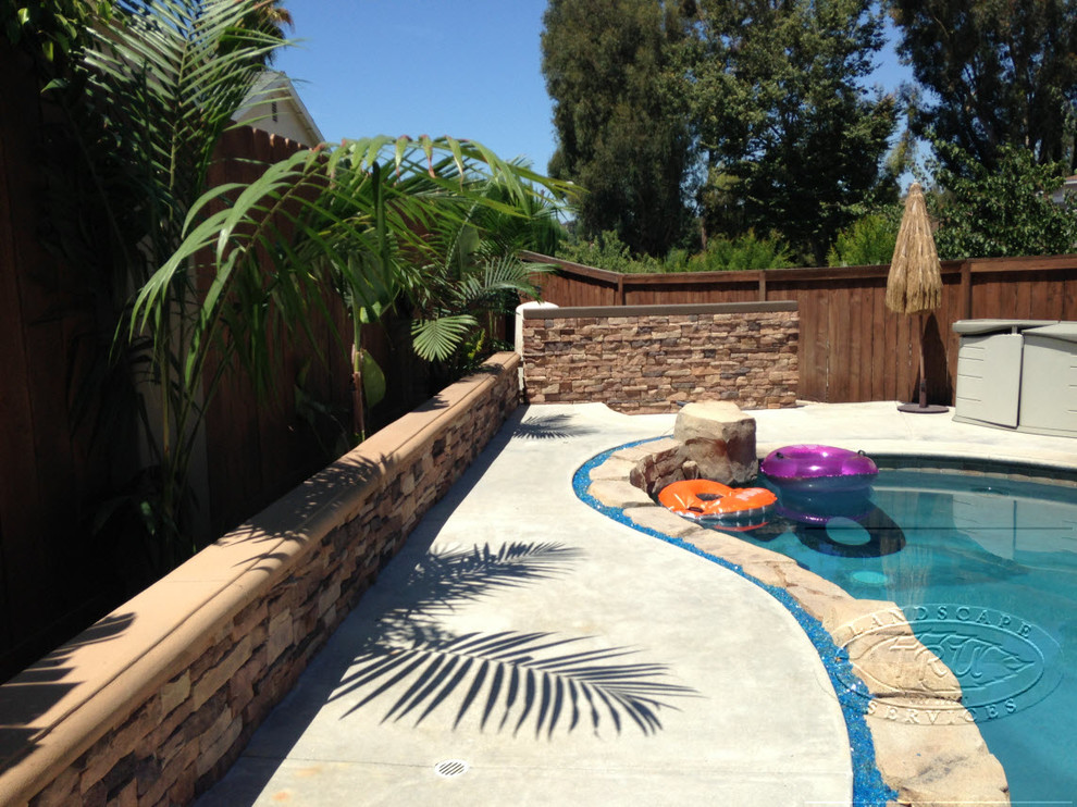 Orange County Pool deck and stacked stone walls - Tropical - Pool ...