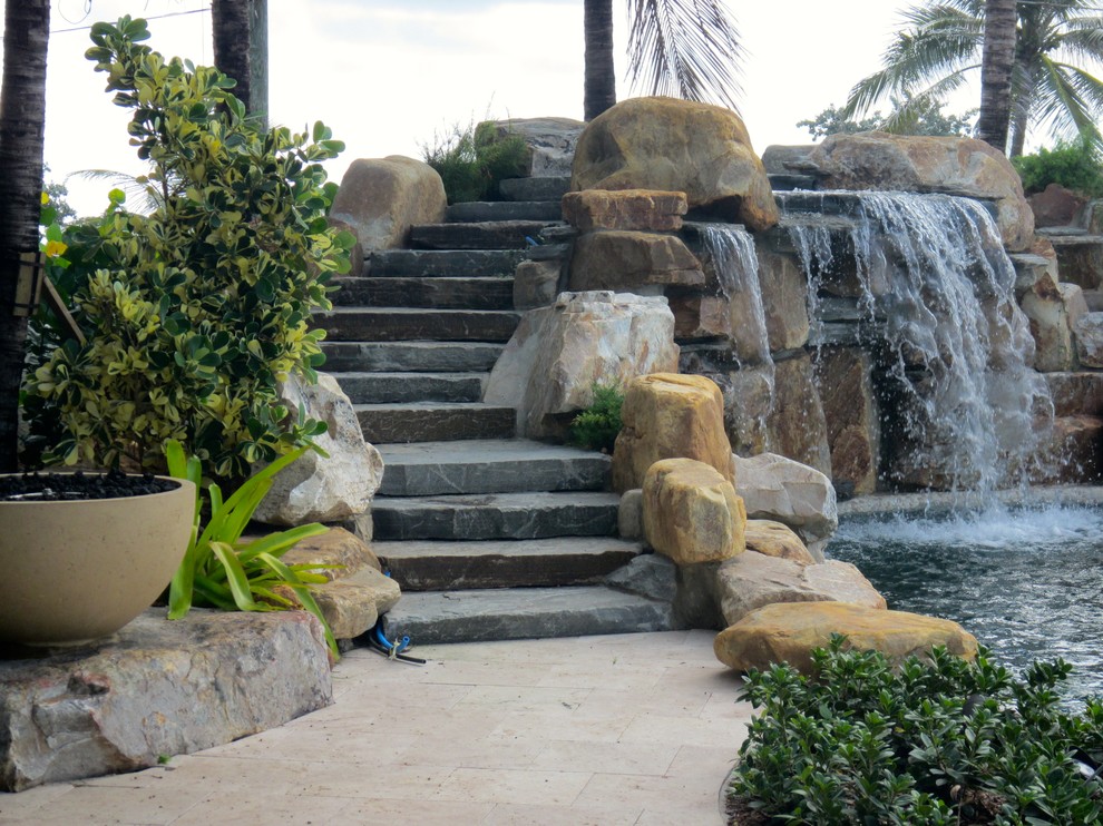 Stone staircase and pool waterfall - Tropical - Pool - Miami - by ...