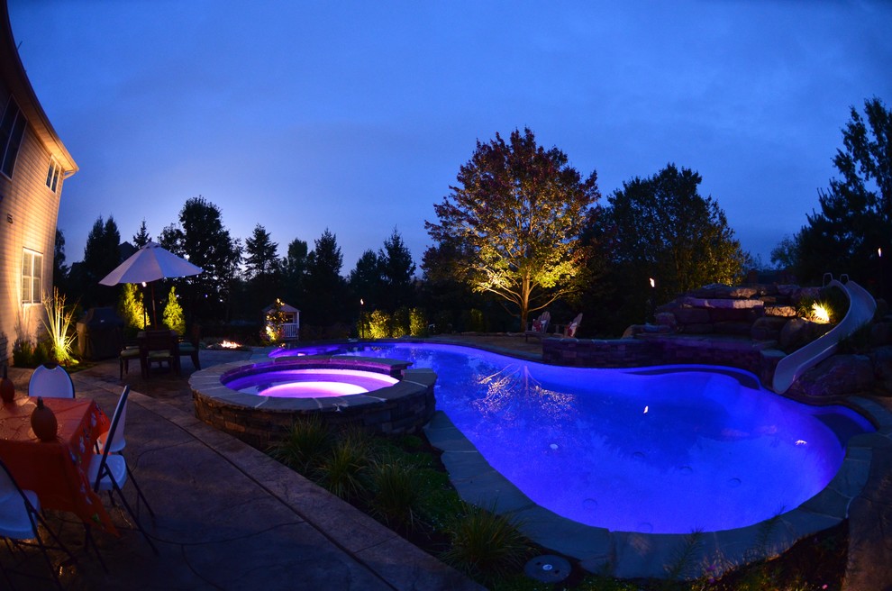 Upper saucon pool with waterslide and swim up bar - Tropical - Pool ...