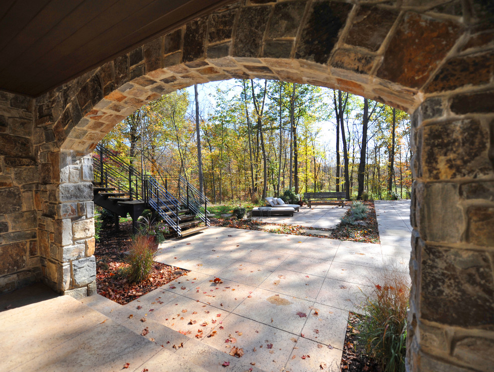Large stone arches at basement walk-out - Traditional - Porch ...