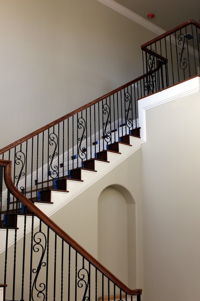 Custom stair with wrought iron balusters & wood handrail - Traditional ...