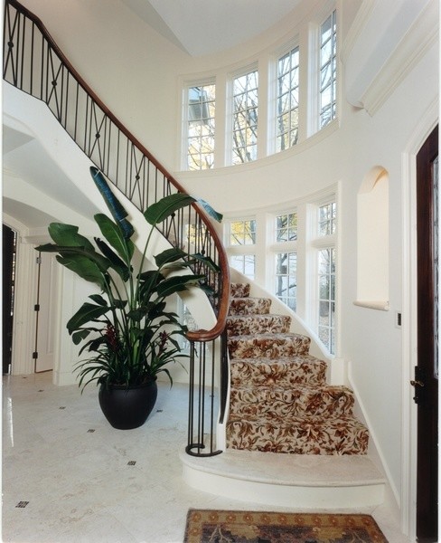 Floating Curved Staircase with Walnut Railing and Iron Balusters ...