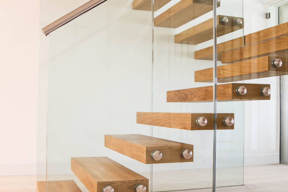 Floating staircase with thick treads and a glass balustrade - Modern ...
