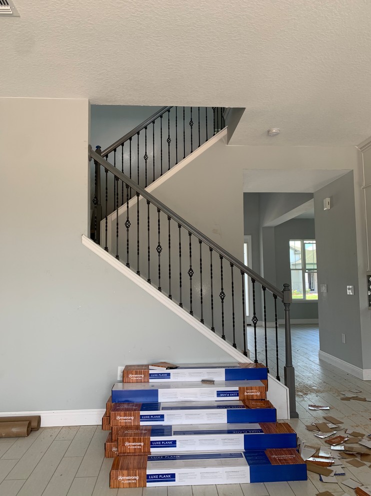 Gray staircase done with basket and double twist iron spindles - Modern ...