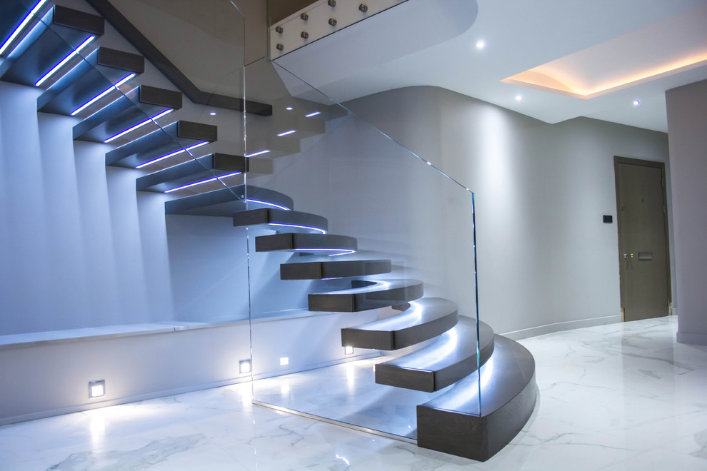 Illuminated floating staircase with huge curved treads - Modern ...