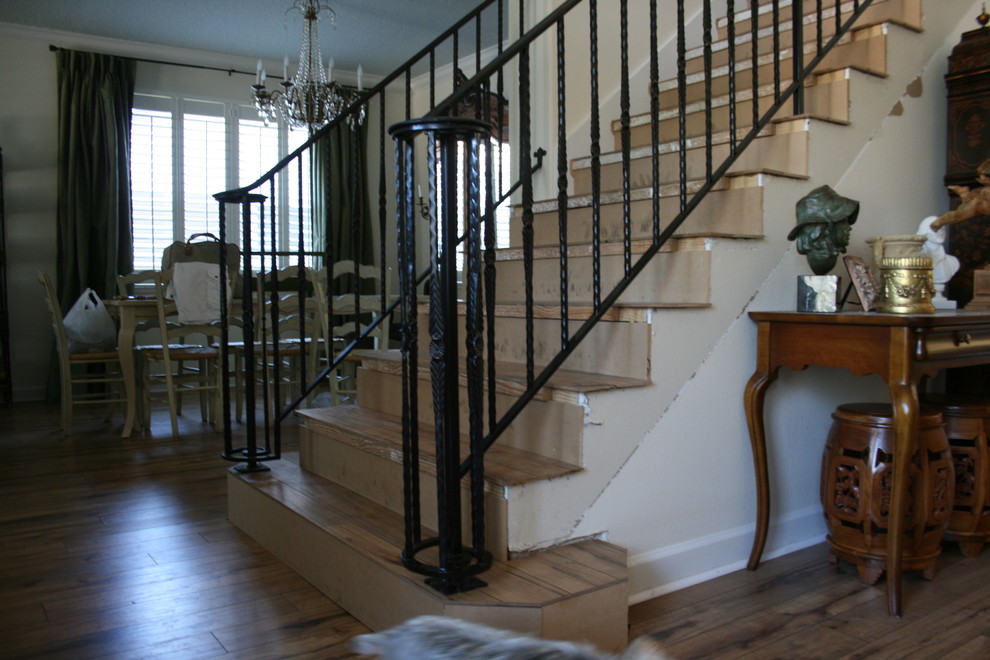 Interior ornamental stair rail with hammered pickets and lateral scroll ...