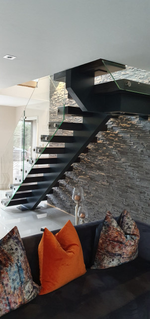 Metal spine stairs with glass balustrade and 10 cm thickness treads ...
