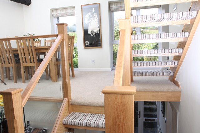 Open-tread oak staircase renovation with embedded glass balustrade ...