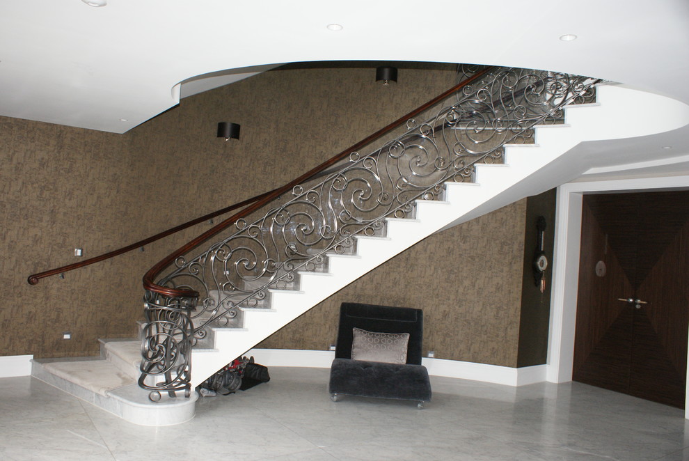 Scrolling forged balustrade around oval stairwell - Traditional ...
