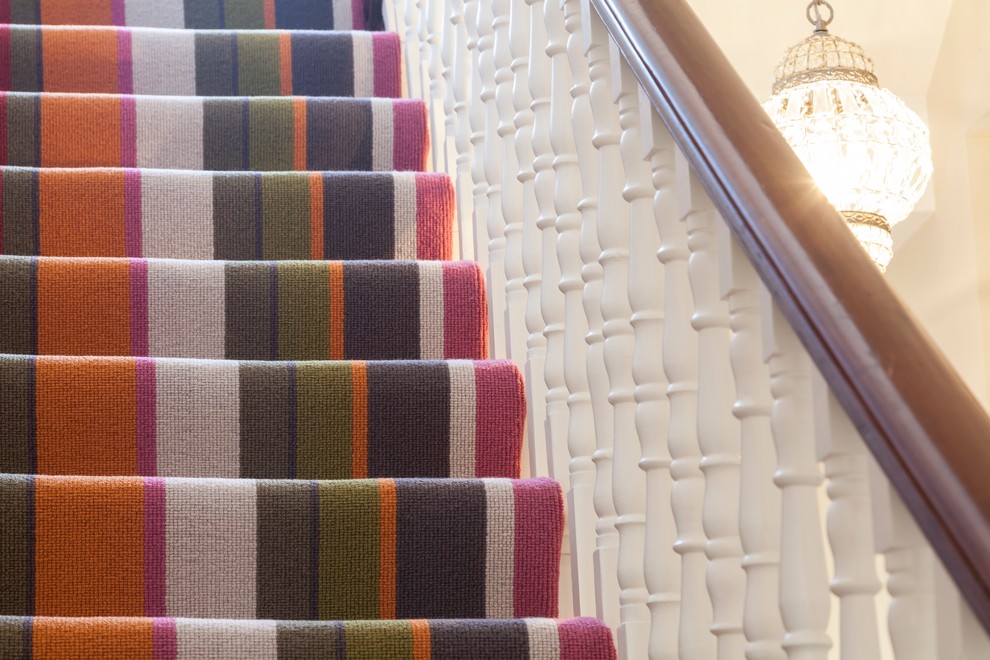 Colourful striped carpet fabric was used to flow down the staircase ...