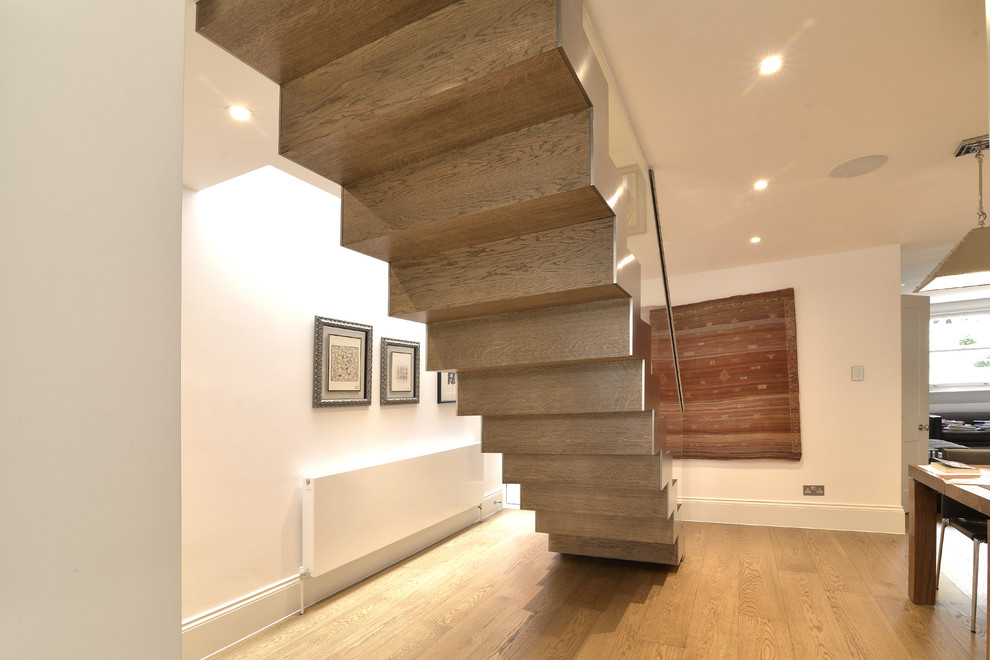 Two straight stairs with offset cantilever timber treads and glass ...