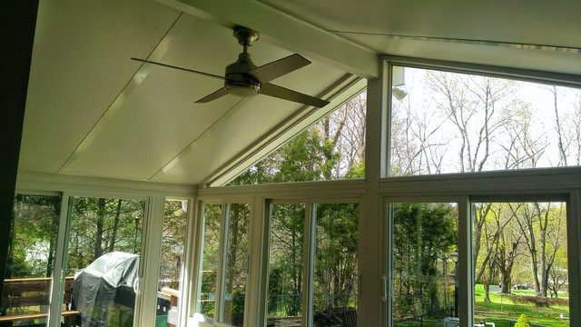 Plenty of glass and ceiling fan hanging from beam. - Contemporary ...