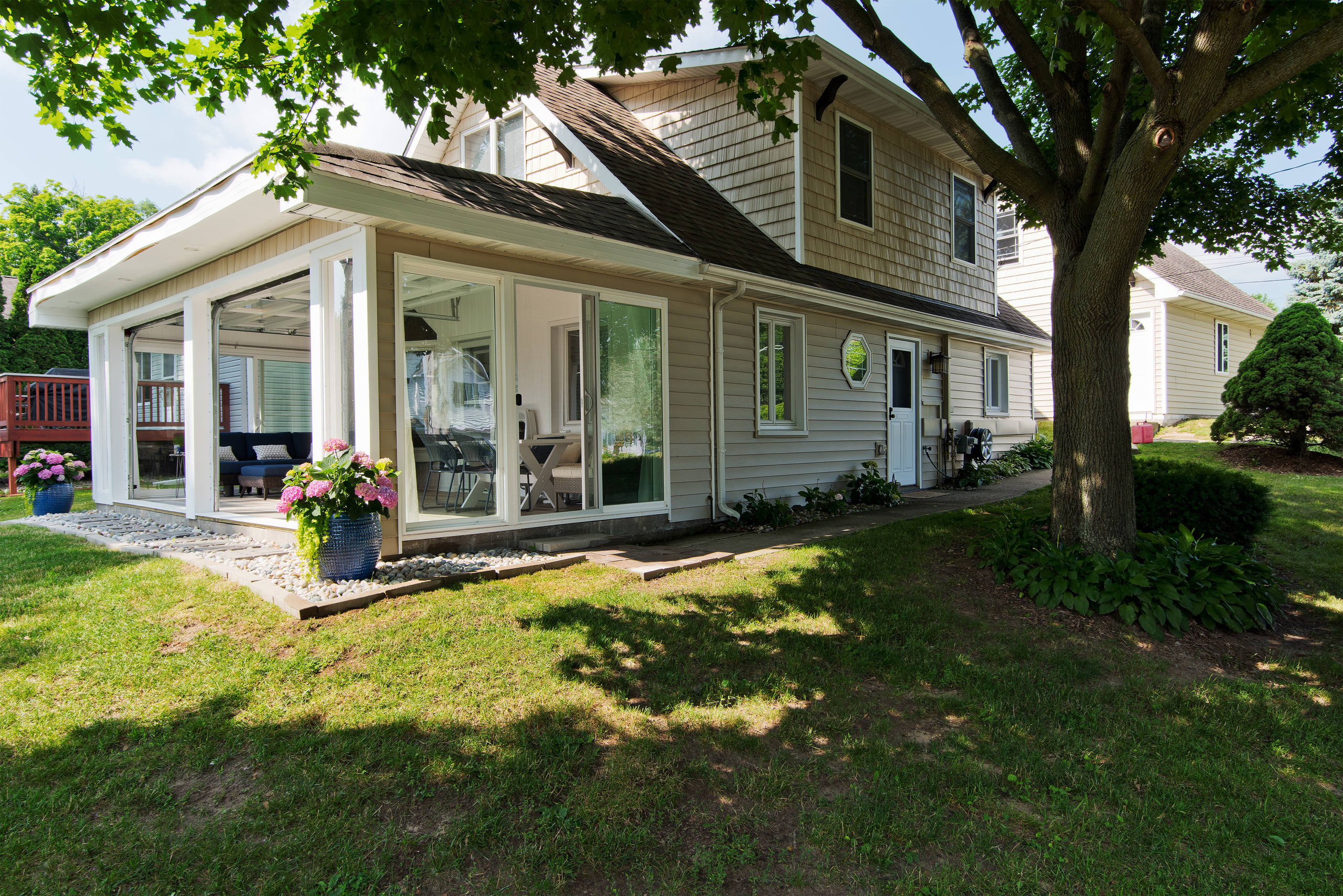 Glass-Paneled Garage Doors Open Up a New Sunroom