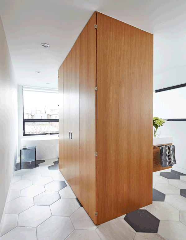 A Clever Storage Box Hides a Laundry Room Inside a Bath